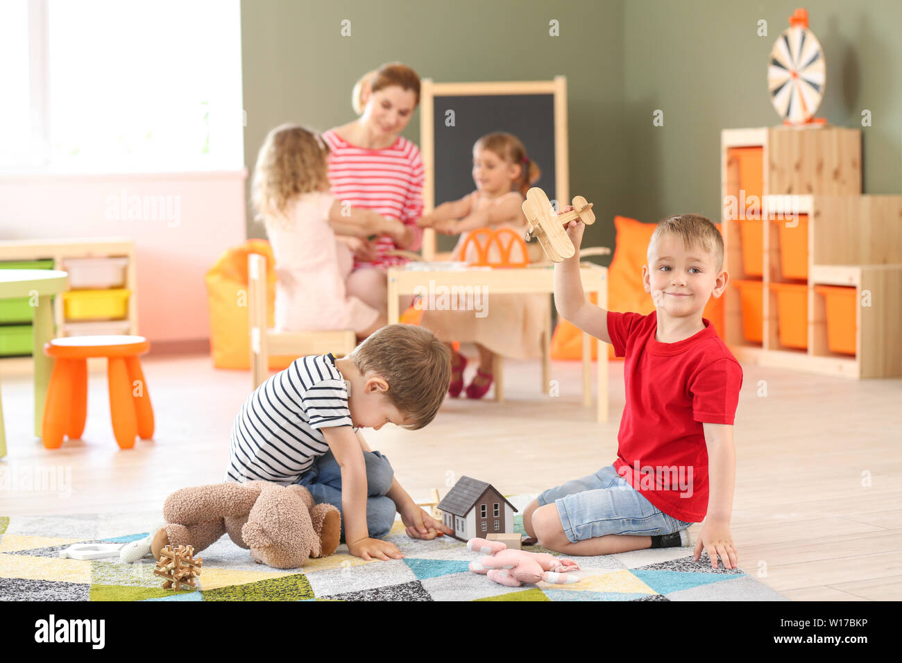 Cute little children playing in kindergarten Stock Photo - Alamy