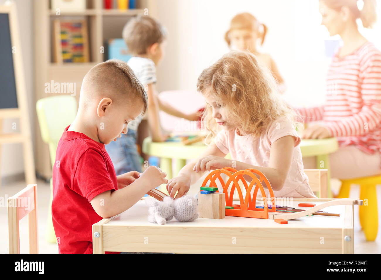 Cute little children playing in kindergarten Stock Photo - Alamy
