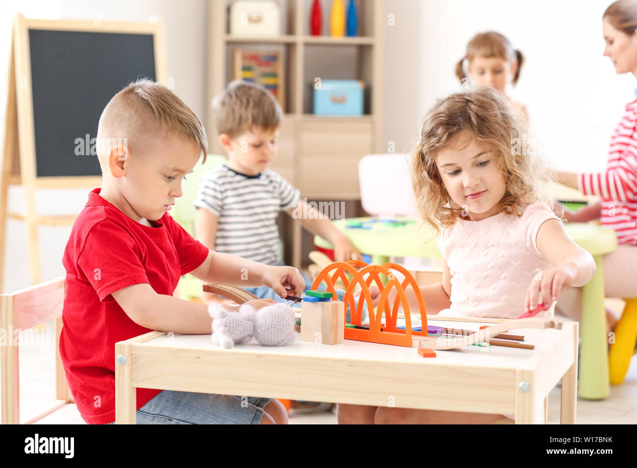 Cute little children playing in kindergarten Stock Photo - Alamy