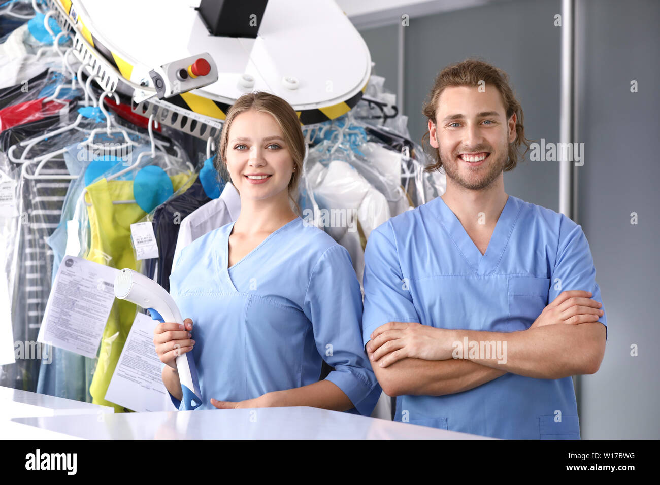 Workers of modern dry-cleaner's at reception Stock Photo - Alamy