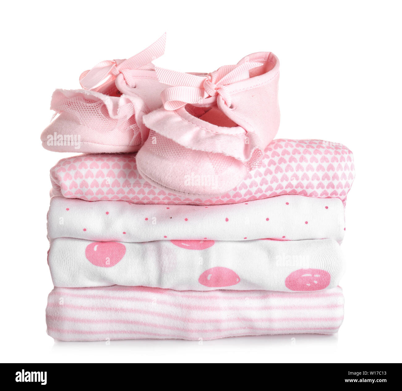 Stack of baby clothes and shoes on white background Stock Photo - Alamy