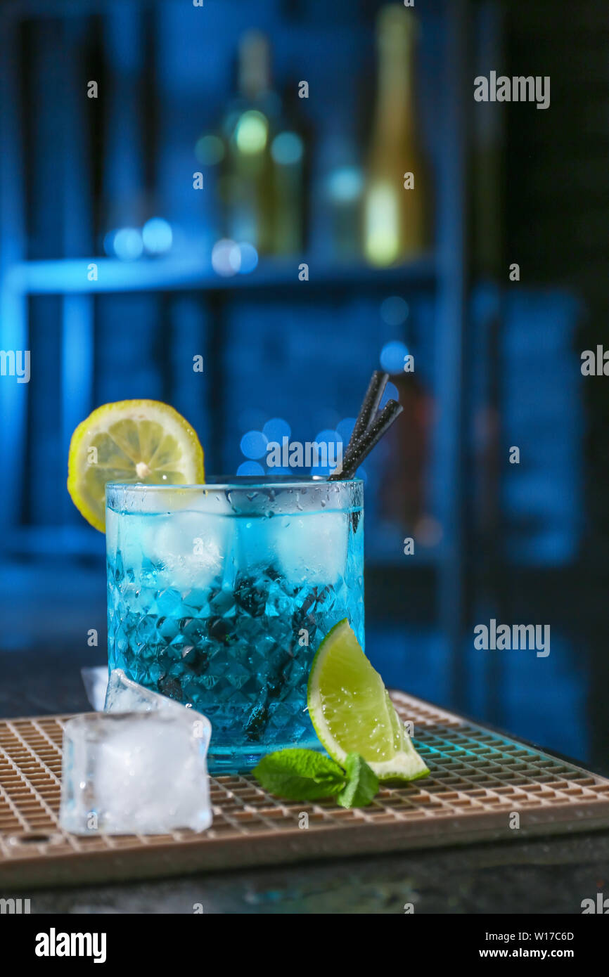 Glass of Blue Lagoon cocktail on table in bar Stock Photo - Alamy