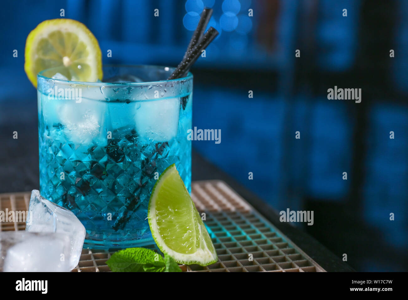 Glass of Blue Lagoon cocktail on table in bar Stock Photo - Alamy