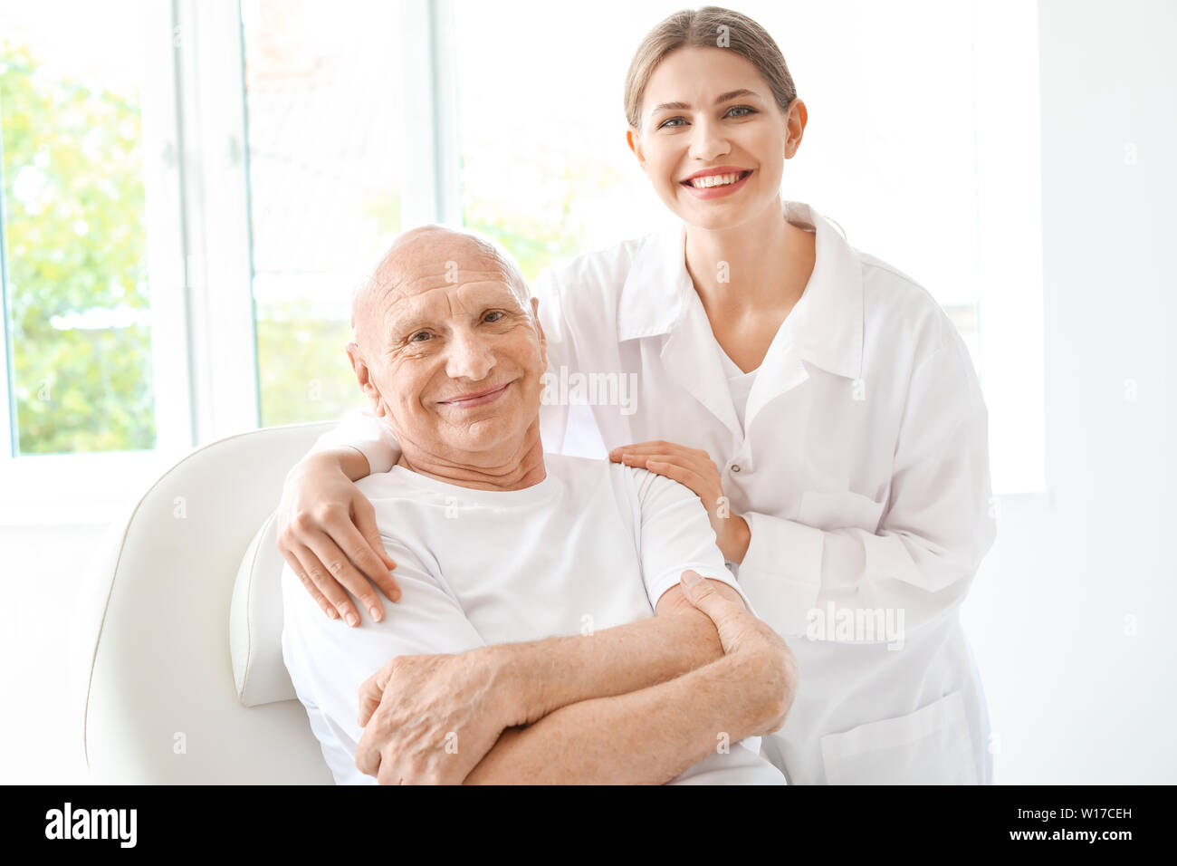 Elderly man with doctor in modern clinic Stock Photo - Alamy