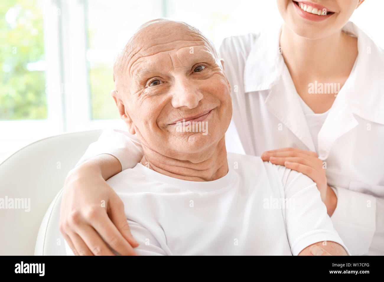 Elderly man with doctor in modern clinic Stock Photo - Alamy