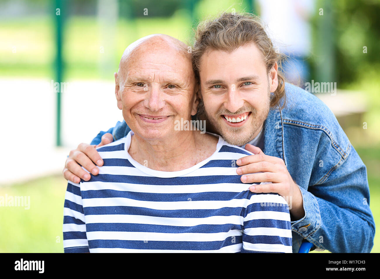 Elderly man with his son in park Stock Photo - Alamy