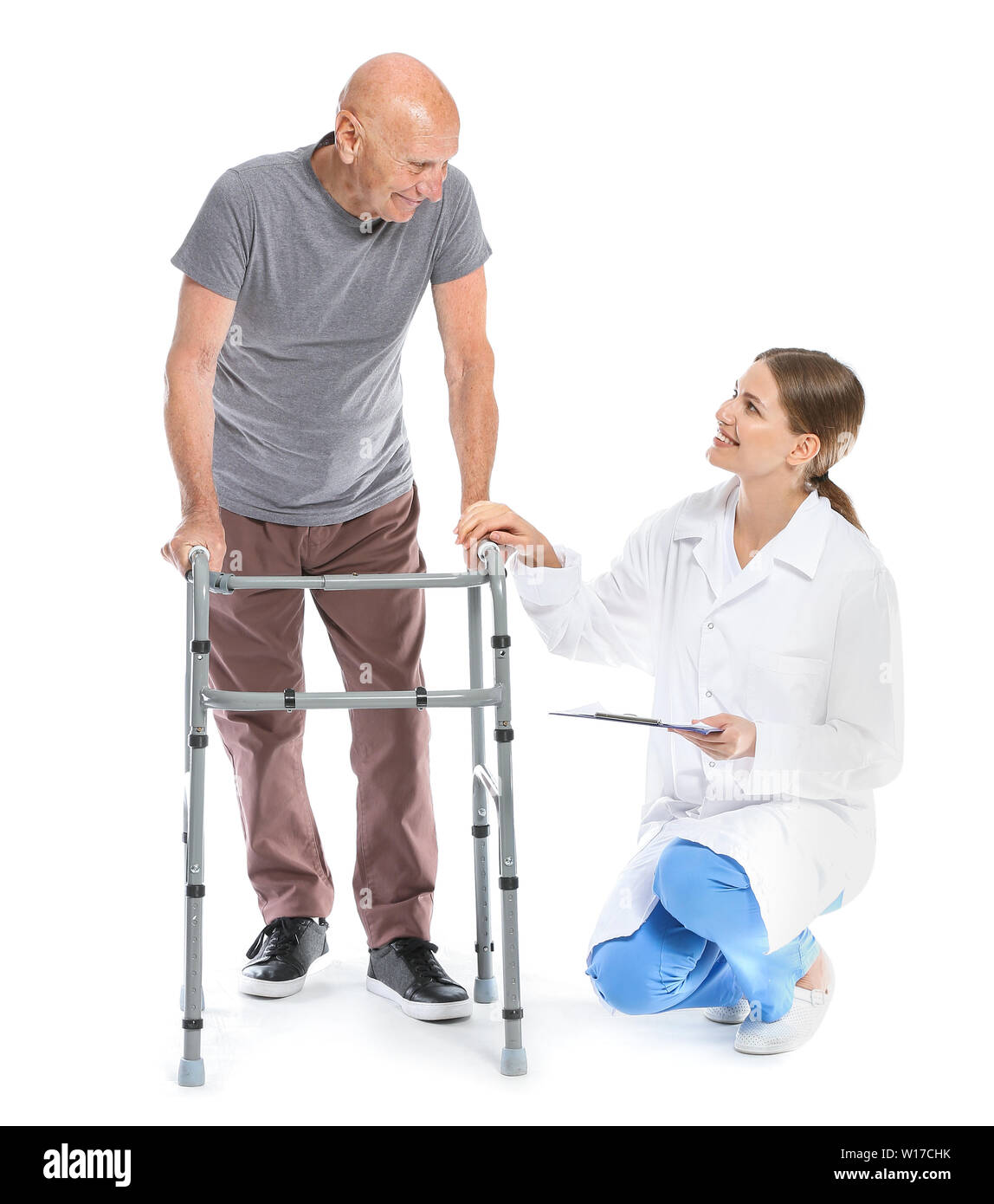 Elderly man with doctor on white background Stock Photo - Alamy