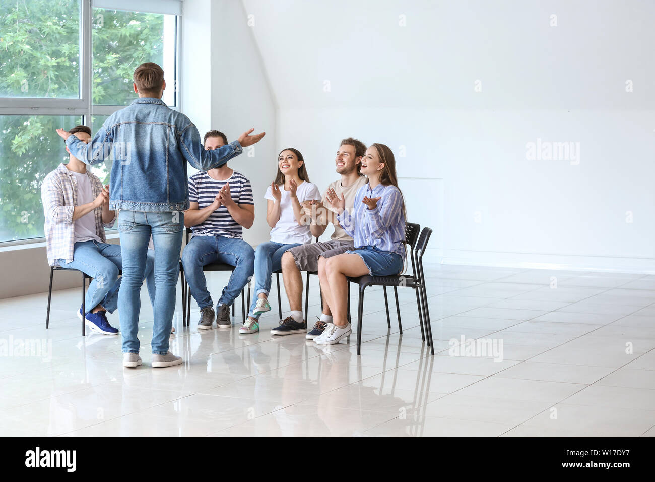 Young people with psychologist at group therapy session Stock Photo - Alamy