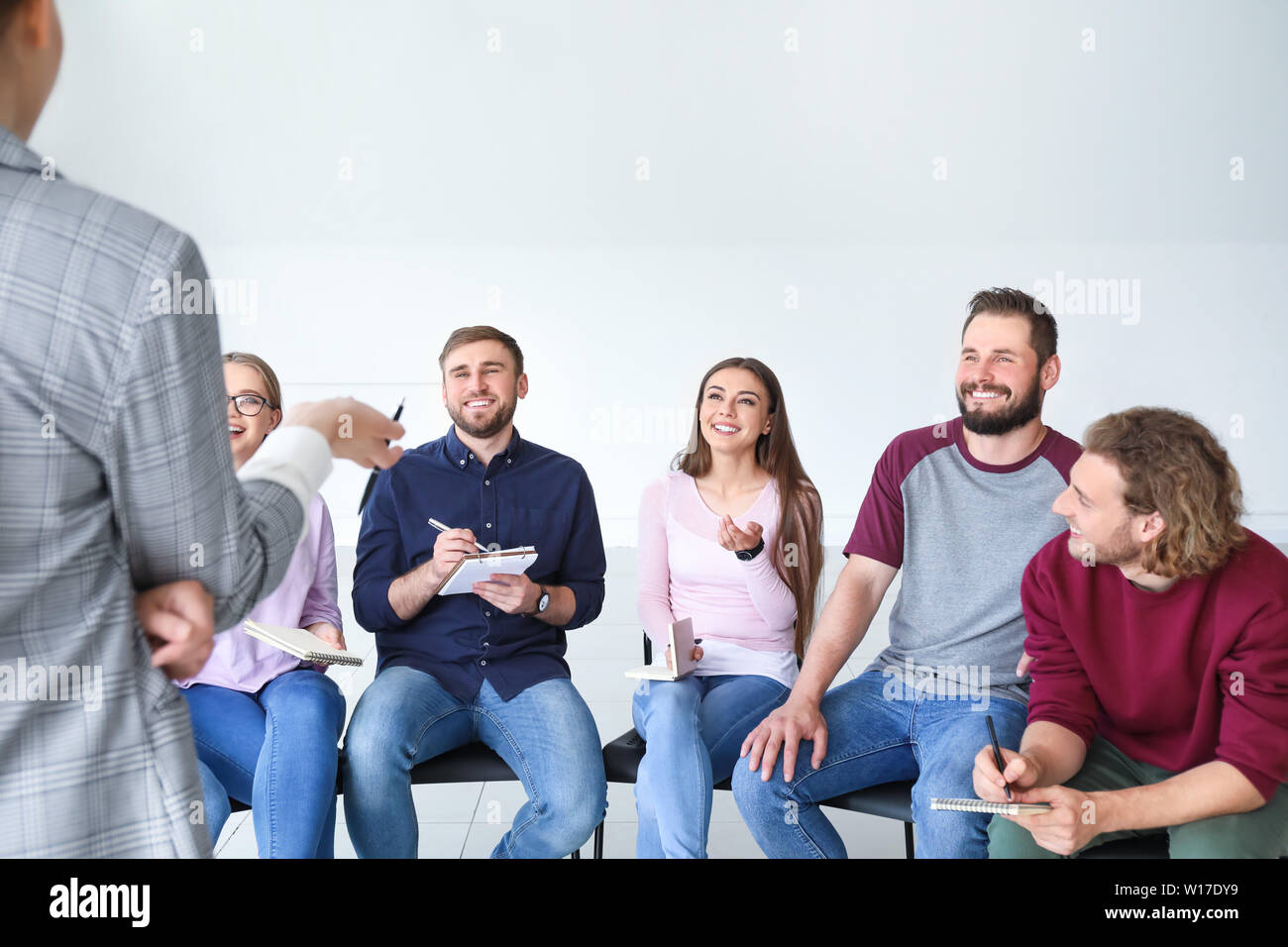 Young people with psychologist at group therapy session Stock Photo - Alamy