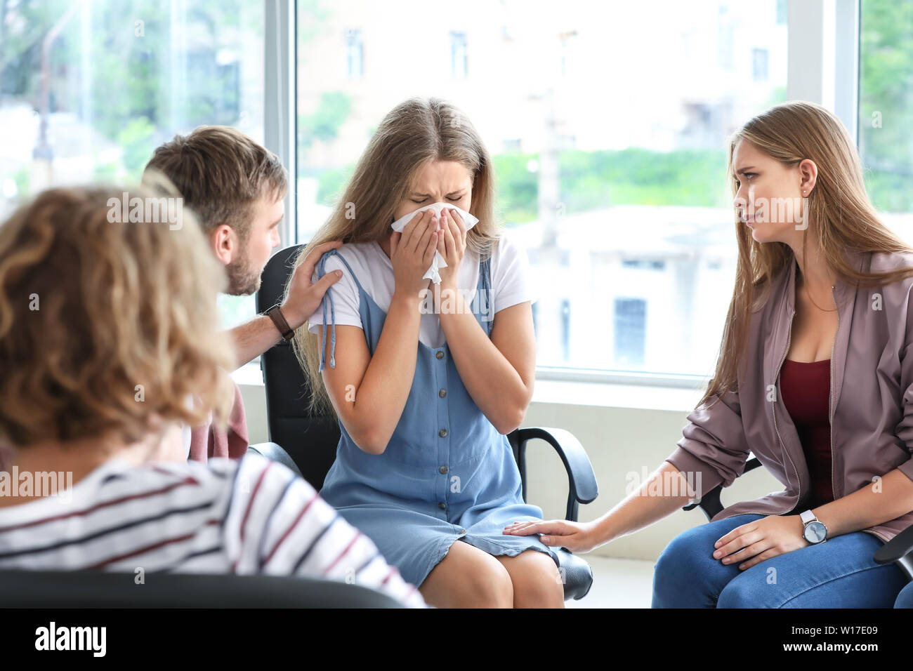 Sad young woman at group therapy session Stock Photo - Alamy
