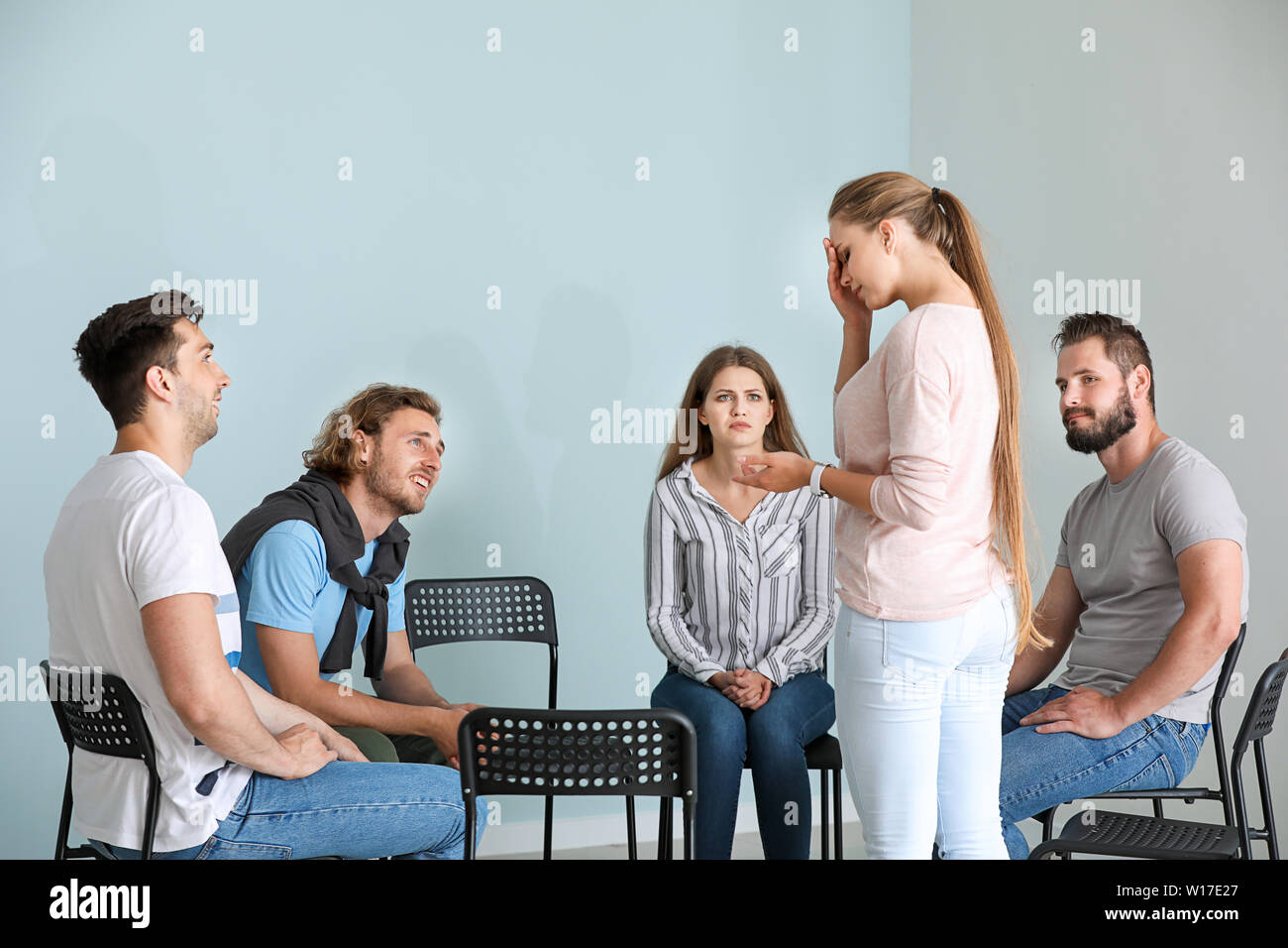 Young woman talking about her problems during group therapy Stock Photo ...
