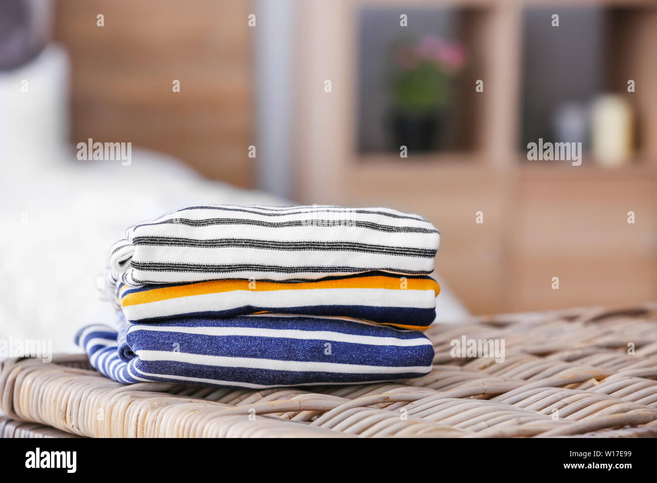 Stack of clean clothes on chest at home Stock Photo - Alamy