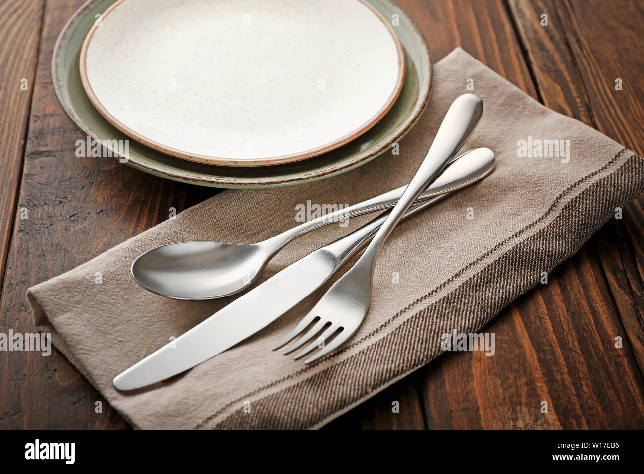 Beautiful table setting on wooden background Stock Photo - Alamy