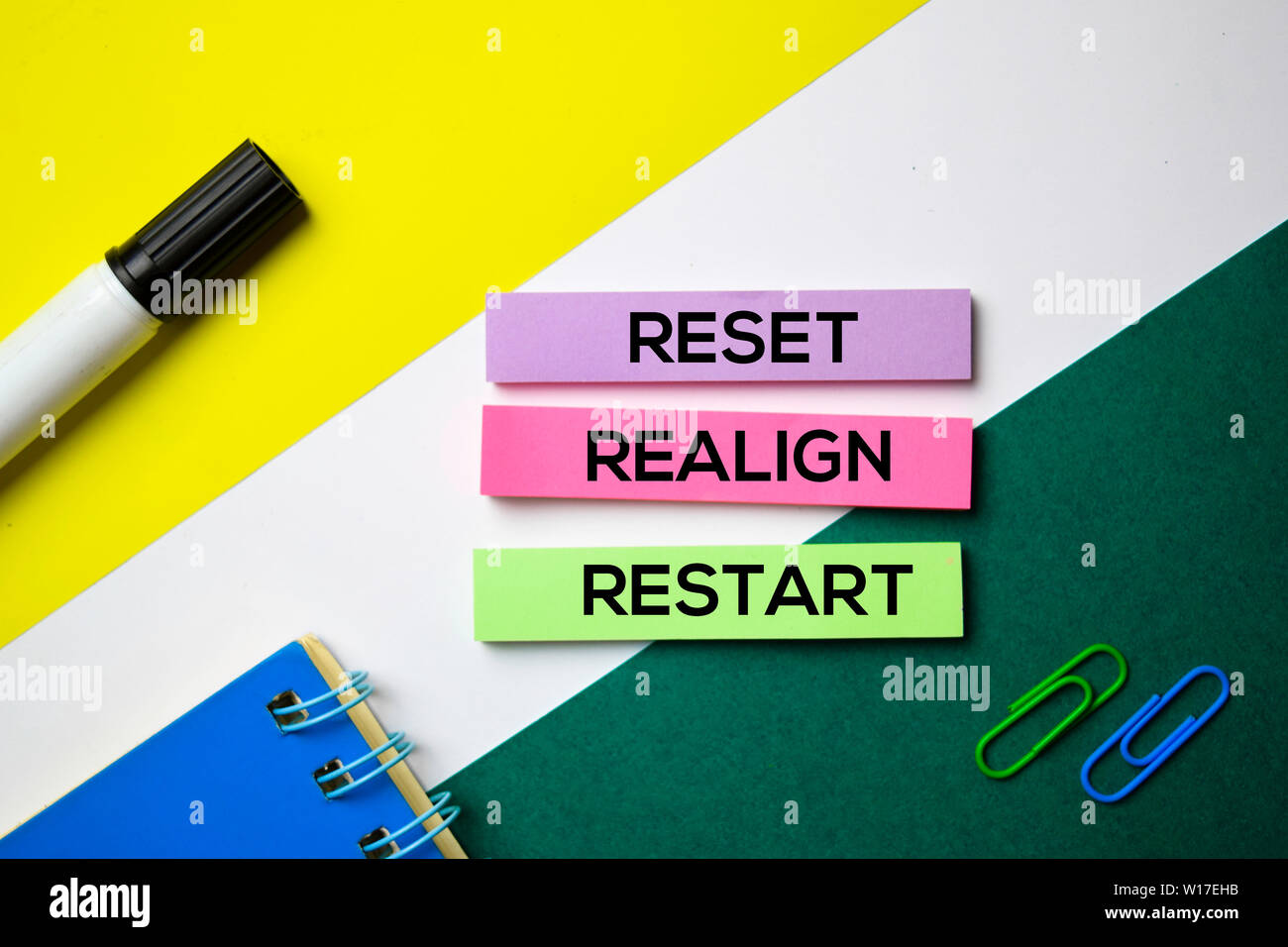 Reset. Realign. Restart text on sticky notes with office desk concept ...