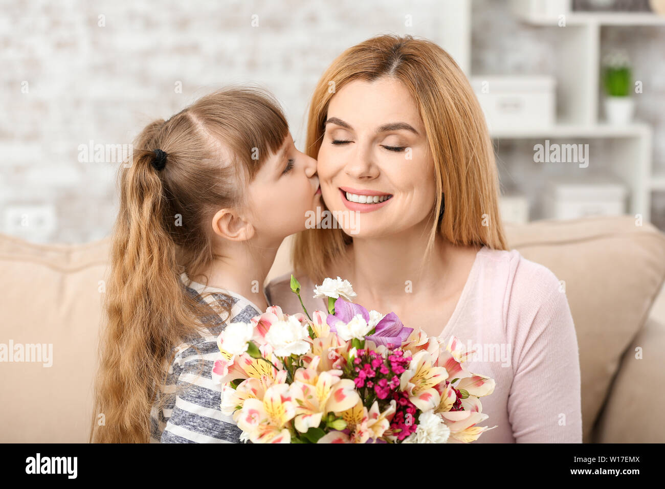 Little girl greeting her mother at home Stock Photo - Alamy