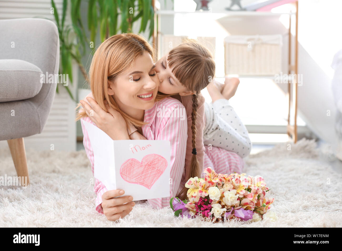 Little girl greeting her mother at home Stock Photo - Alamy