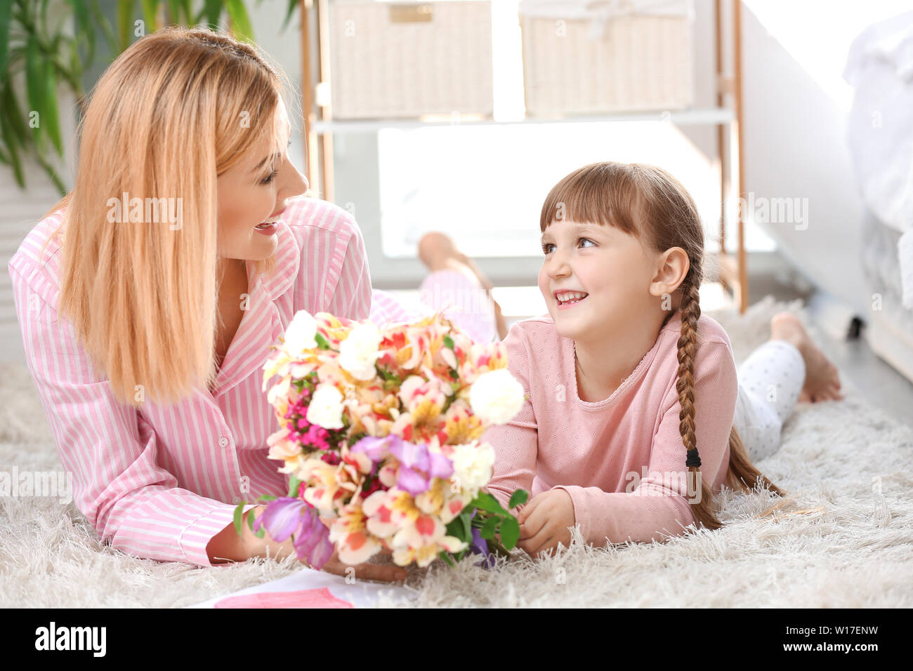 Little girl greeting her mother at home Stock Photo - Alamy