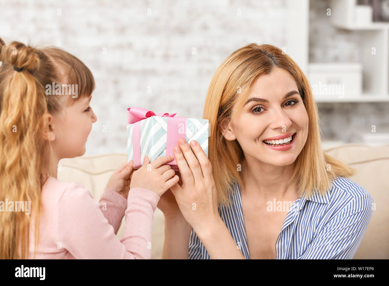 Little girl greeting her mother at home Stock Photo - Alamy