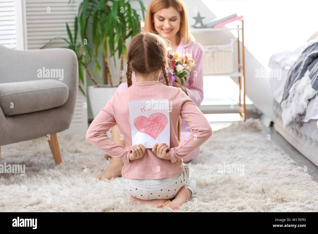 Little girl greeting her mother at home Stock Photo - Alamy