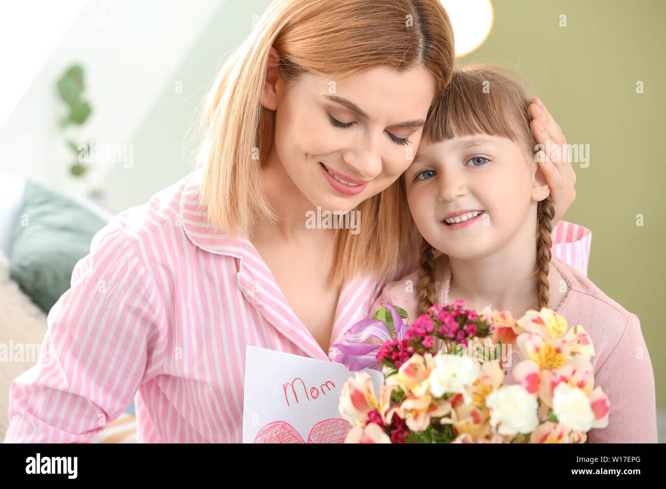 Little girl greeting her mother at home Stock Photo - Alamy