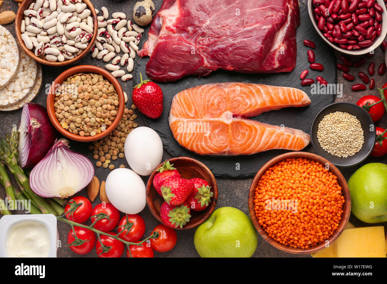 Different healthy food on grey background Stock Photo - Alamy