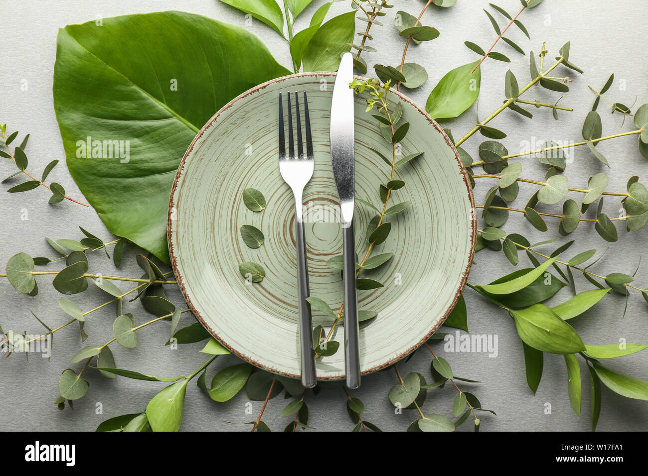 Simple table setting with tropical leaves Stock Photo - Alamy