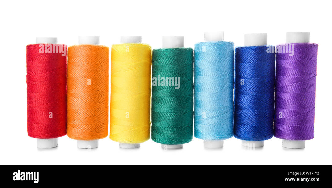 Colorful sewing threads on white background Stock Photo - Alamy