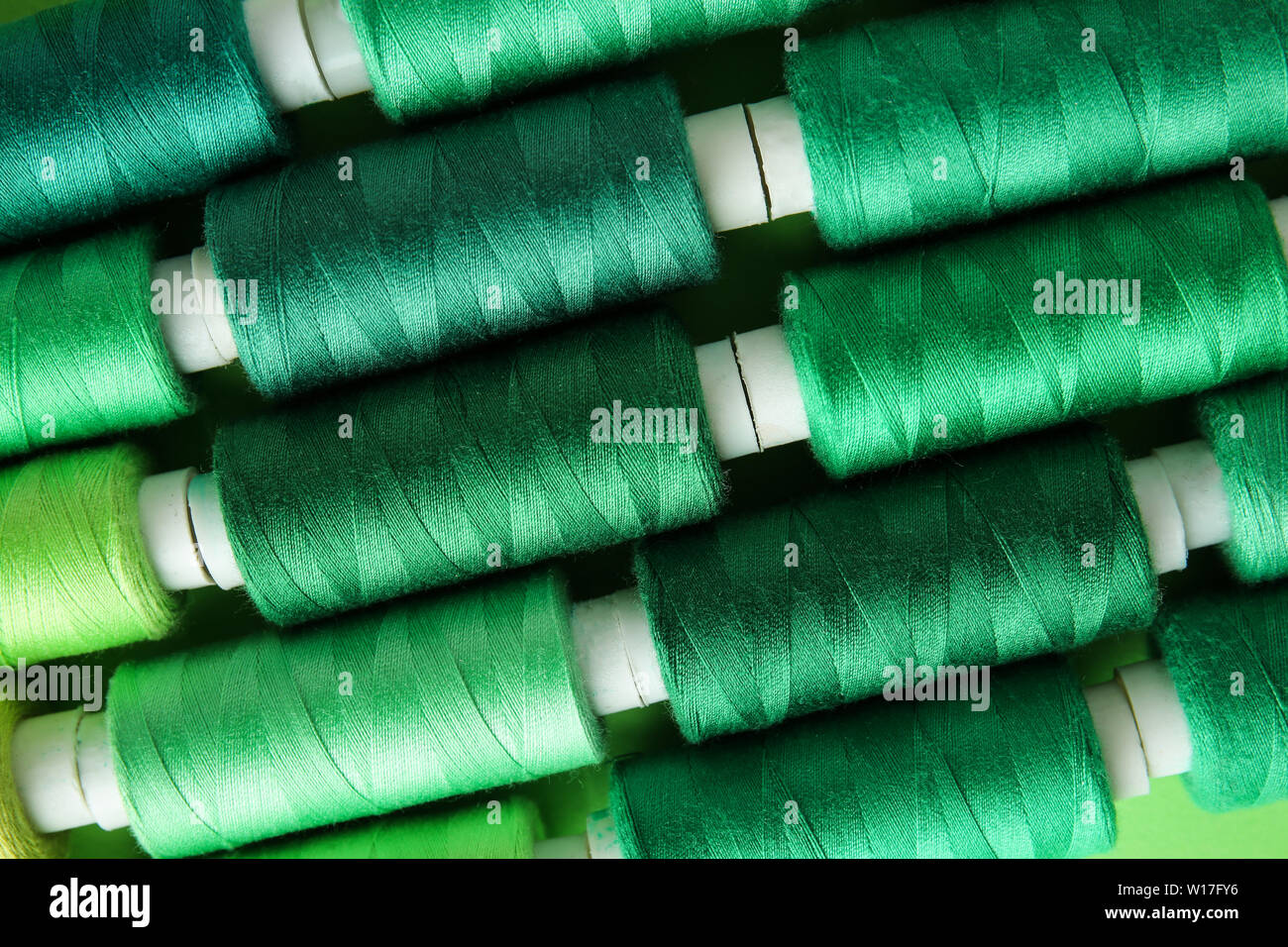 Many colorful sewing threads as background Stock Photo - Alamy