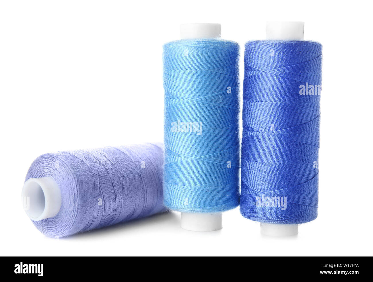 Bright sewing threads on white background Stock Photo - Alamy