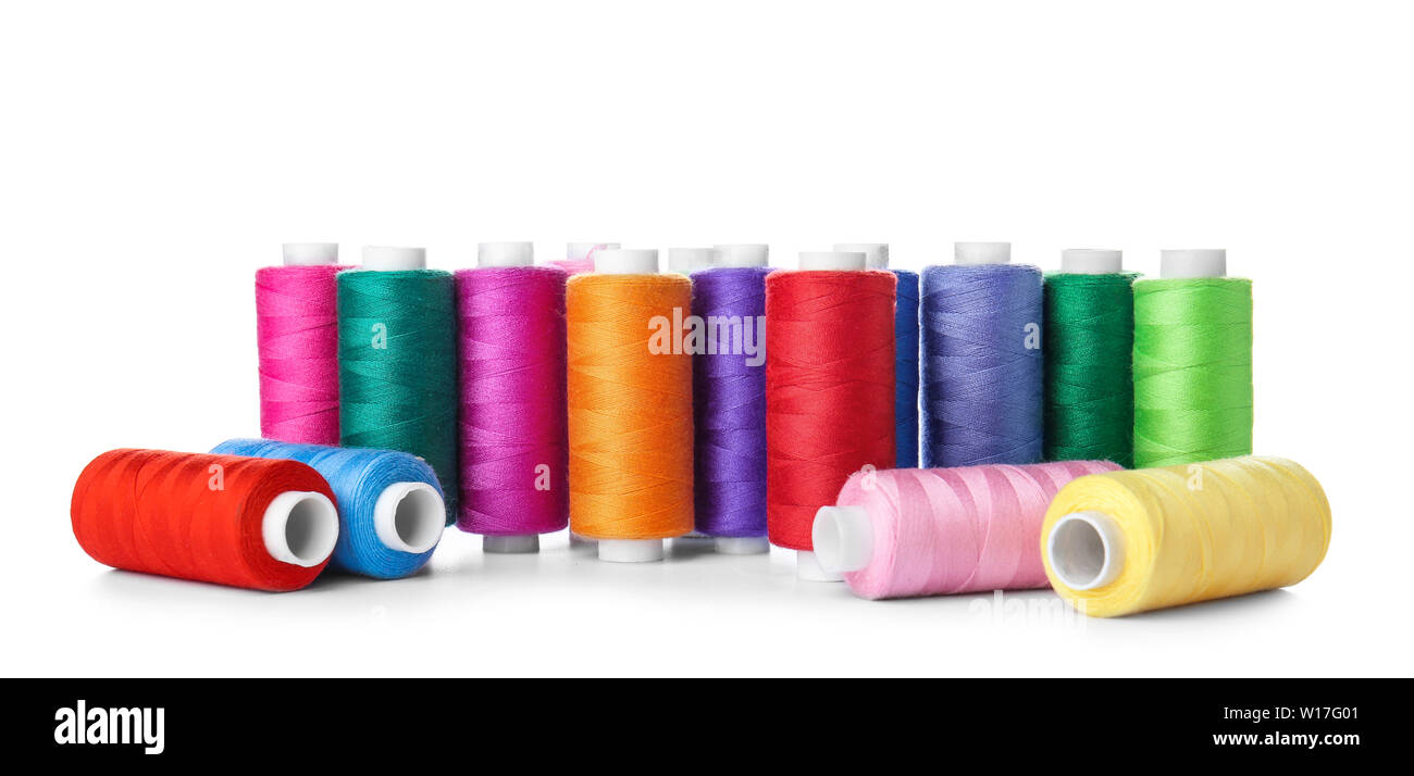 Colorful sewing threads on white background Stock Photo - Alamy