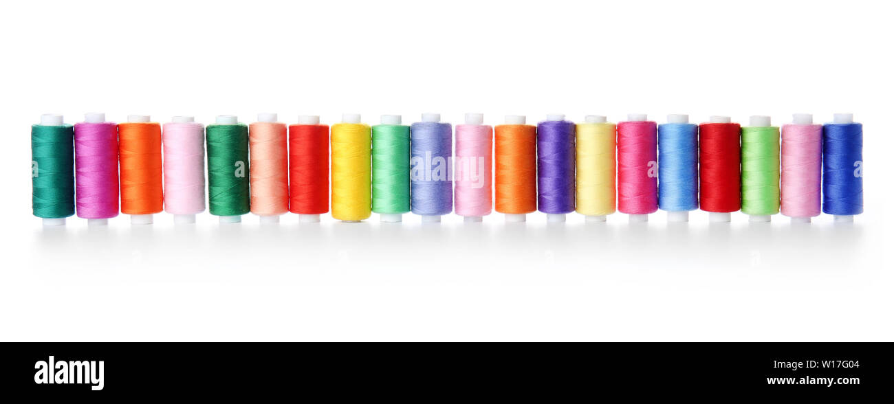 Colorful sewing threads on white background Stock Photo - Alamy