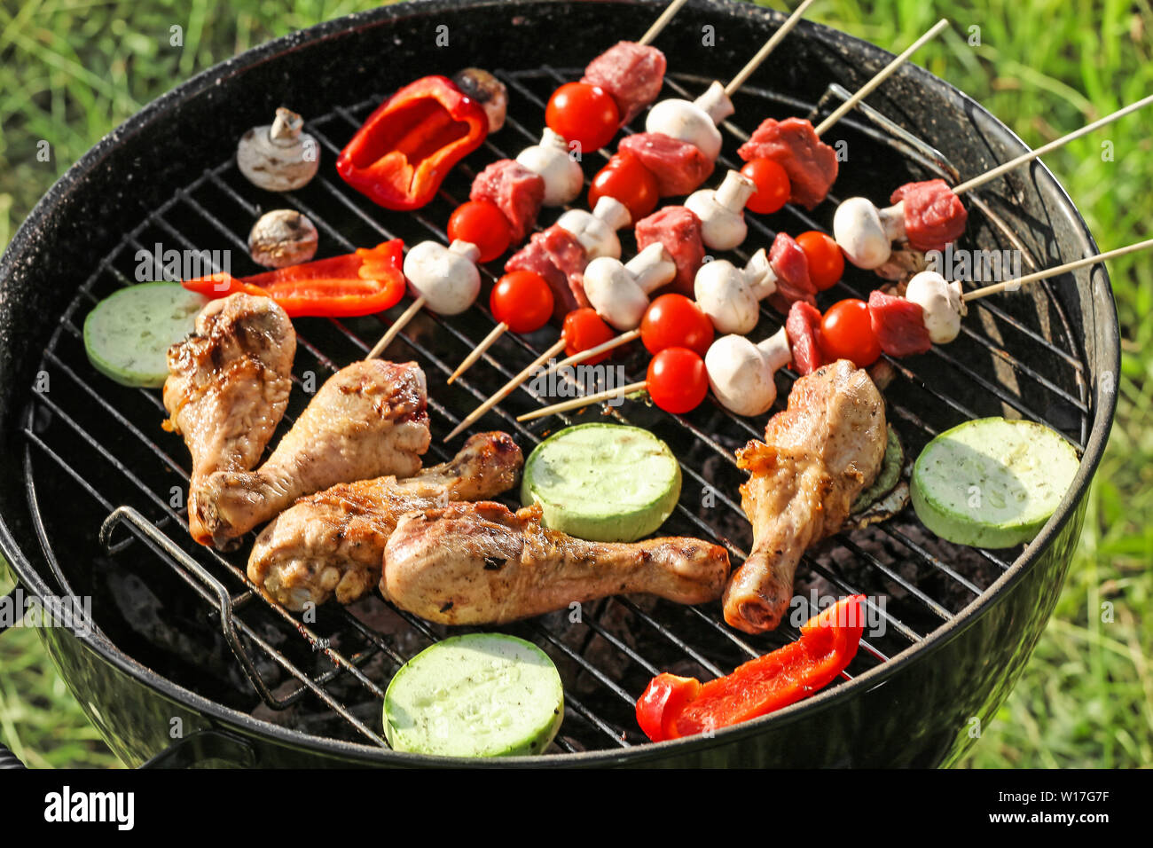 Cooking of tasty food on barbecue grill outdoors, closeup Stock Photo ...