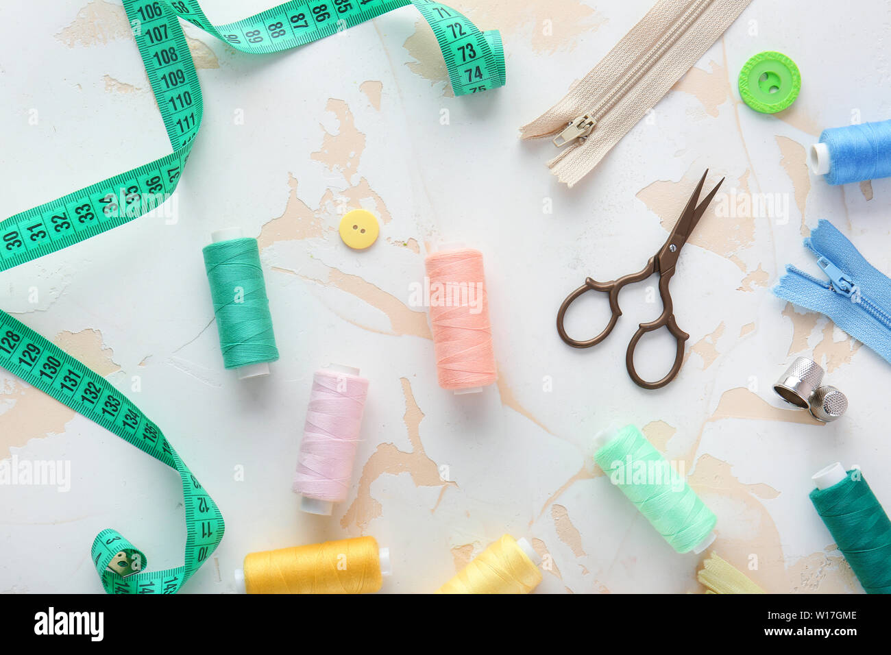 Set of sewing threads and accessories on light background Stock Photo ...