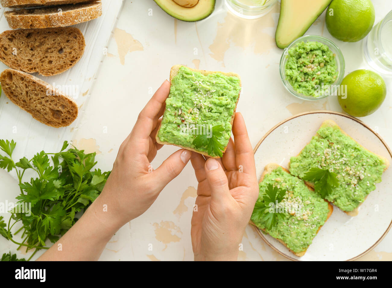 Woman eating toast holding hi-res stock photography and images - Alamy
