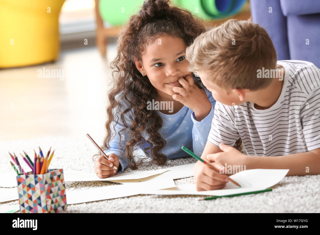 Happy adopted children drawing pictures in their new home Stock Photo ...