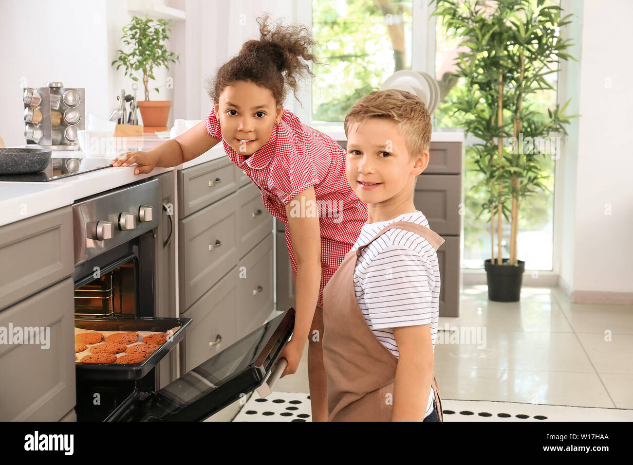 Little children baking tasty cookies at home Stock Photo - Alamy