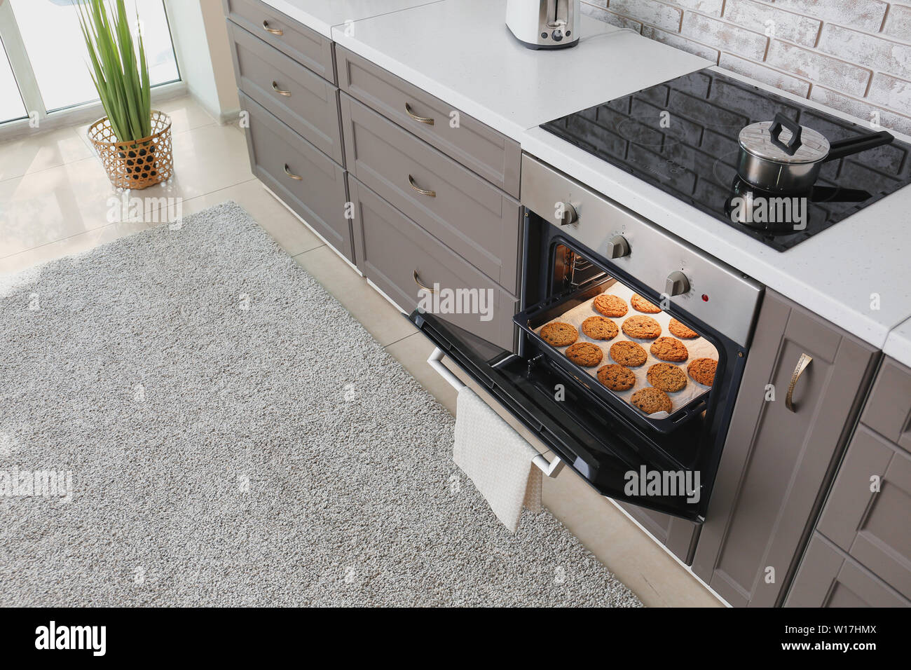 Open oven with tasty homemade cookies in kitchen Stock Photo - Alamy