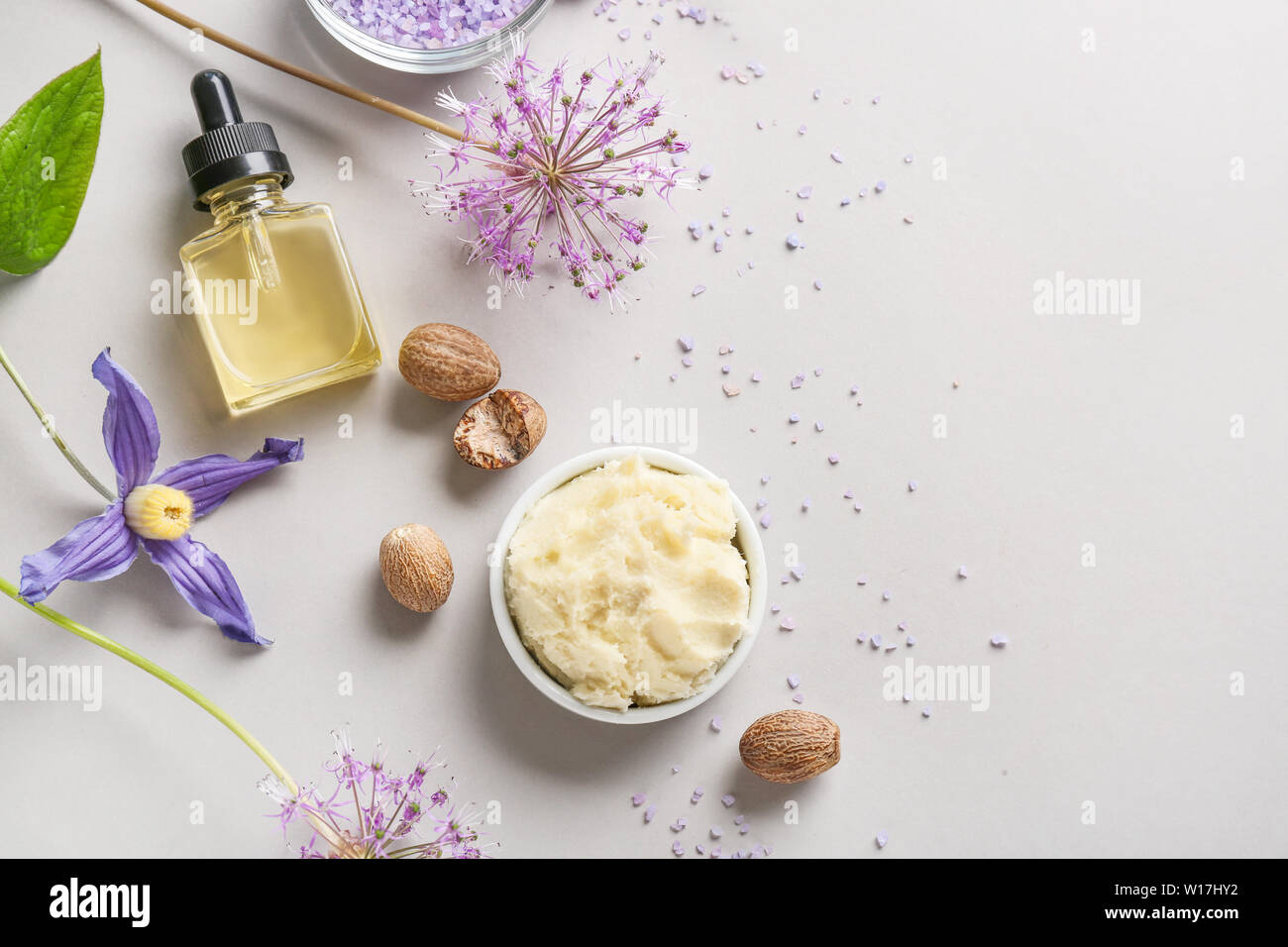 Shea butter with cosmetic products on grey background Stock Photo - Alamy