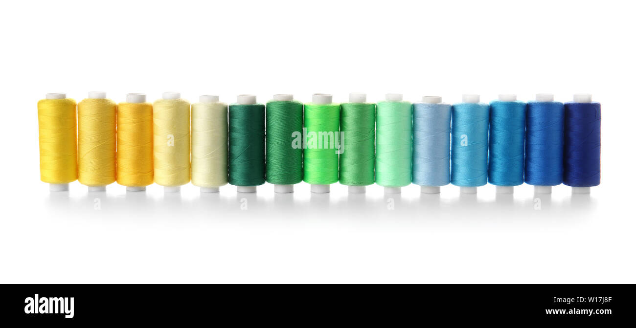 Colorful sewing threads on white background Stock Photo - Alamy