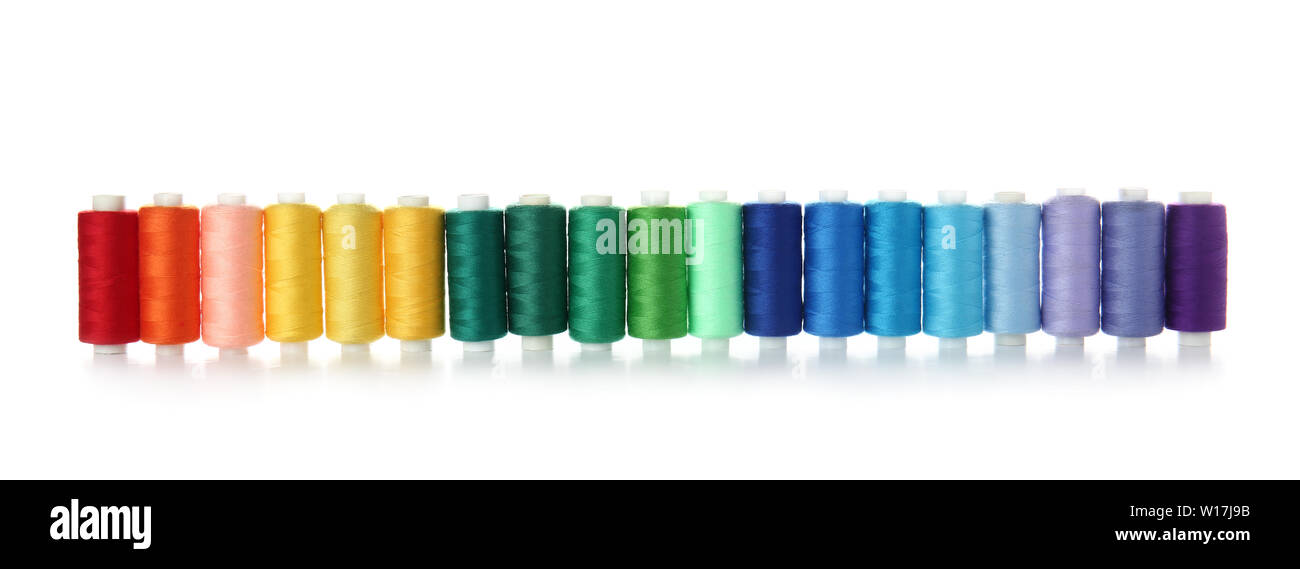 Colorful sewing threads on white background Stock Photo - Alamy