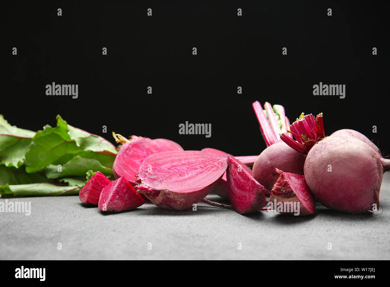 Fresh beet on grey table against dark background Stock Photo - Alamy