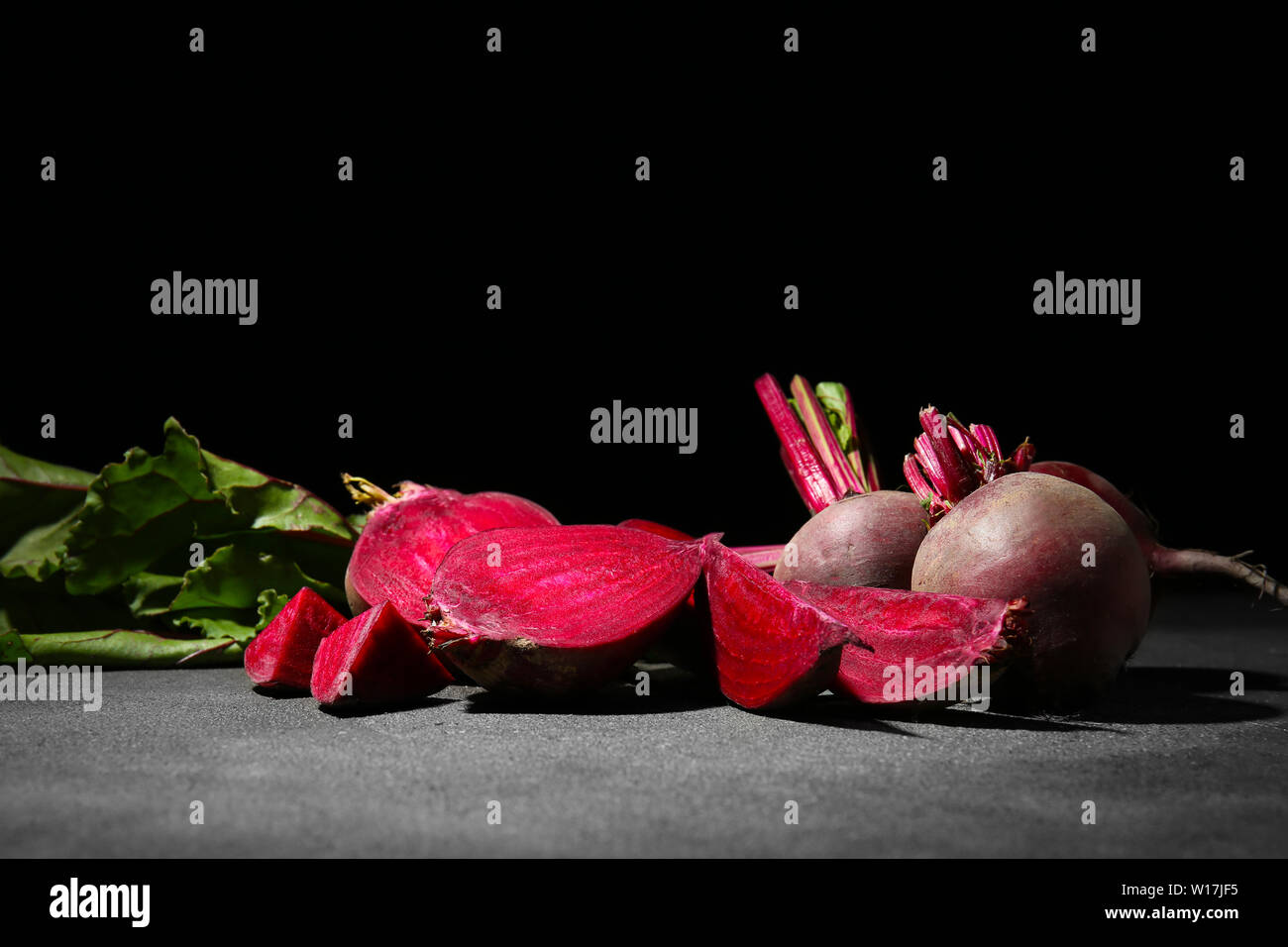 Fresh beet on grey table against dark background Stock Photo - Alamy