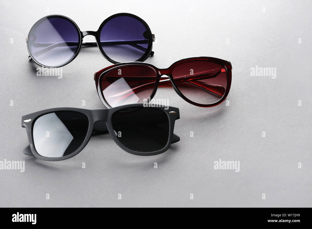 Modern sunglasses on grey background Stock Photo - Alamy