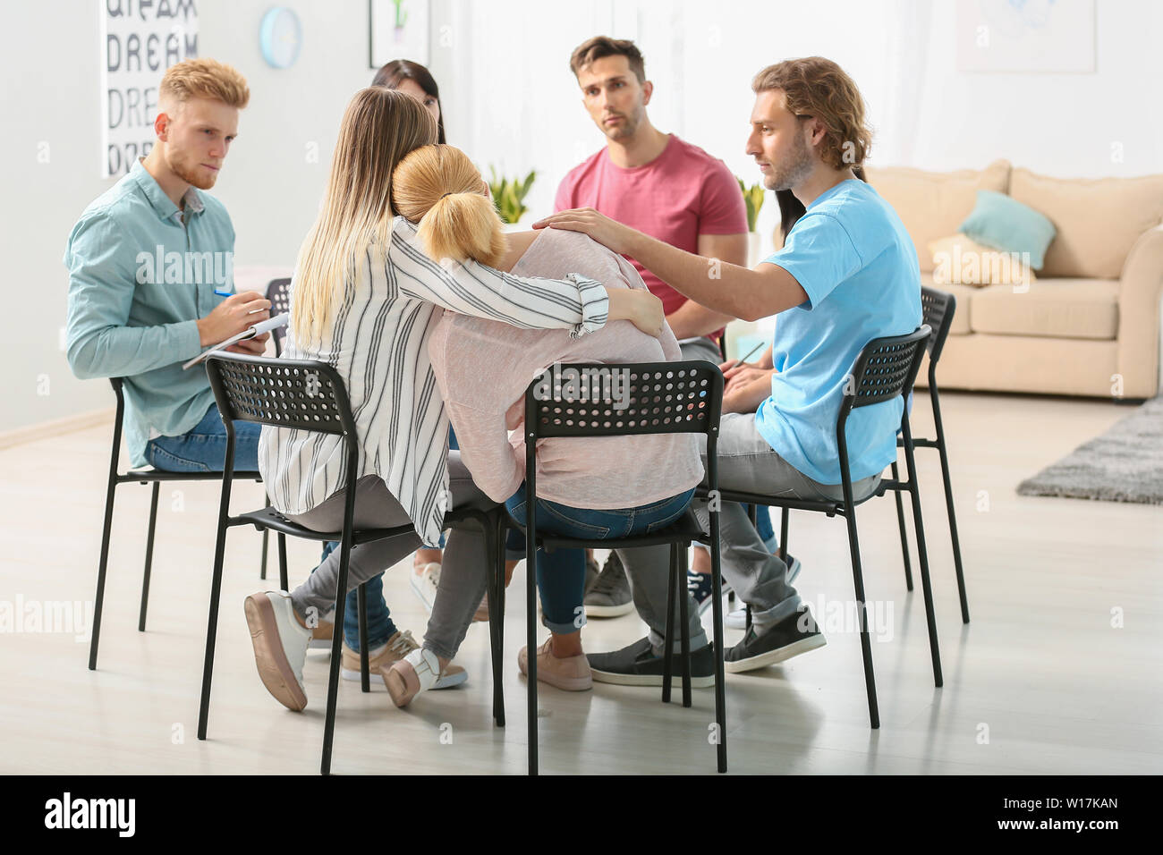 People calming woman at group therapy session Stock Photo - Alamy