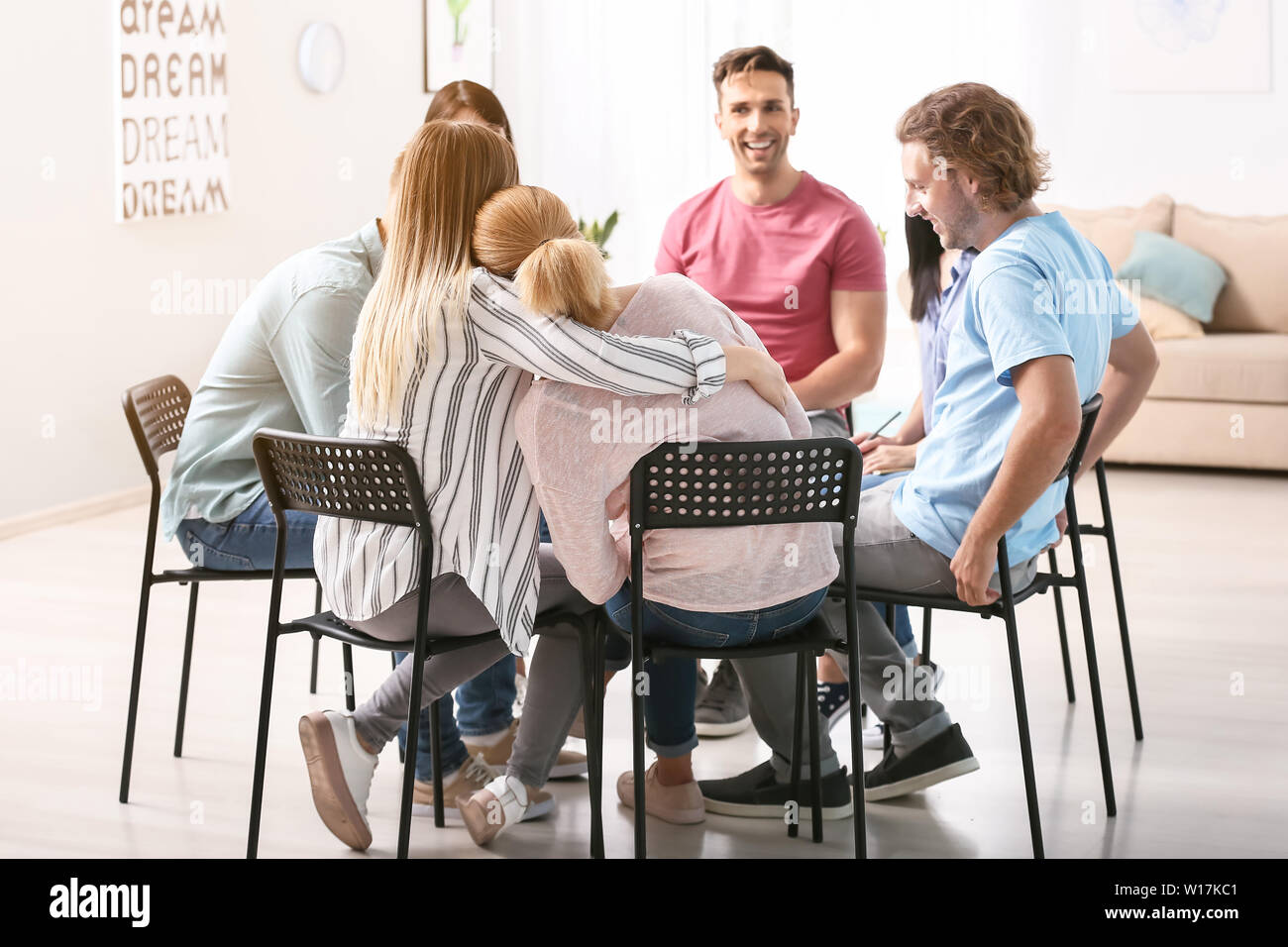 People calming woman at group therapy session Stock Photo - Alamy