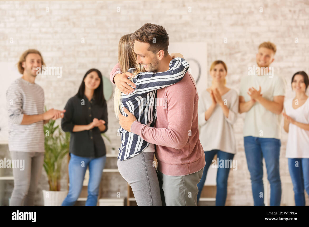 People hugging at group therapy session Stock Photo - Alamy