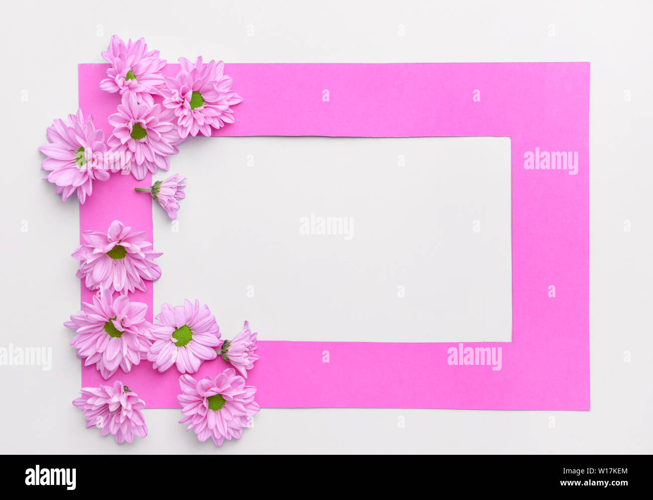 Beautiful fresh flowers and frame on light background Stock Photo - Alamy
