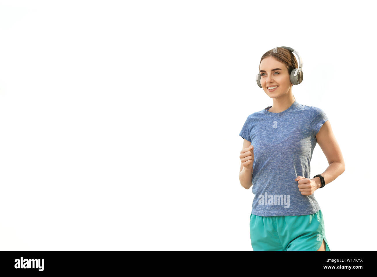 Sporty running young woman on white background Stock Photo - Alamy