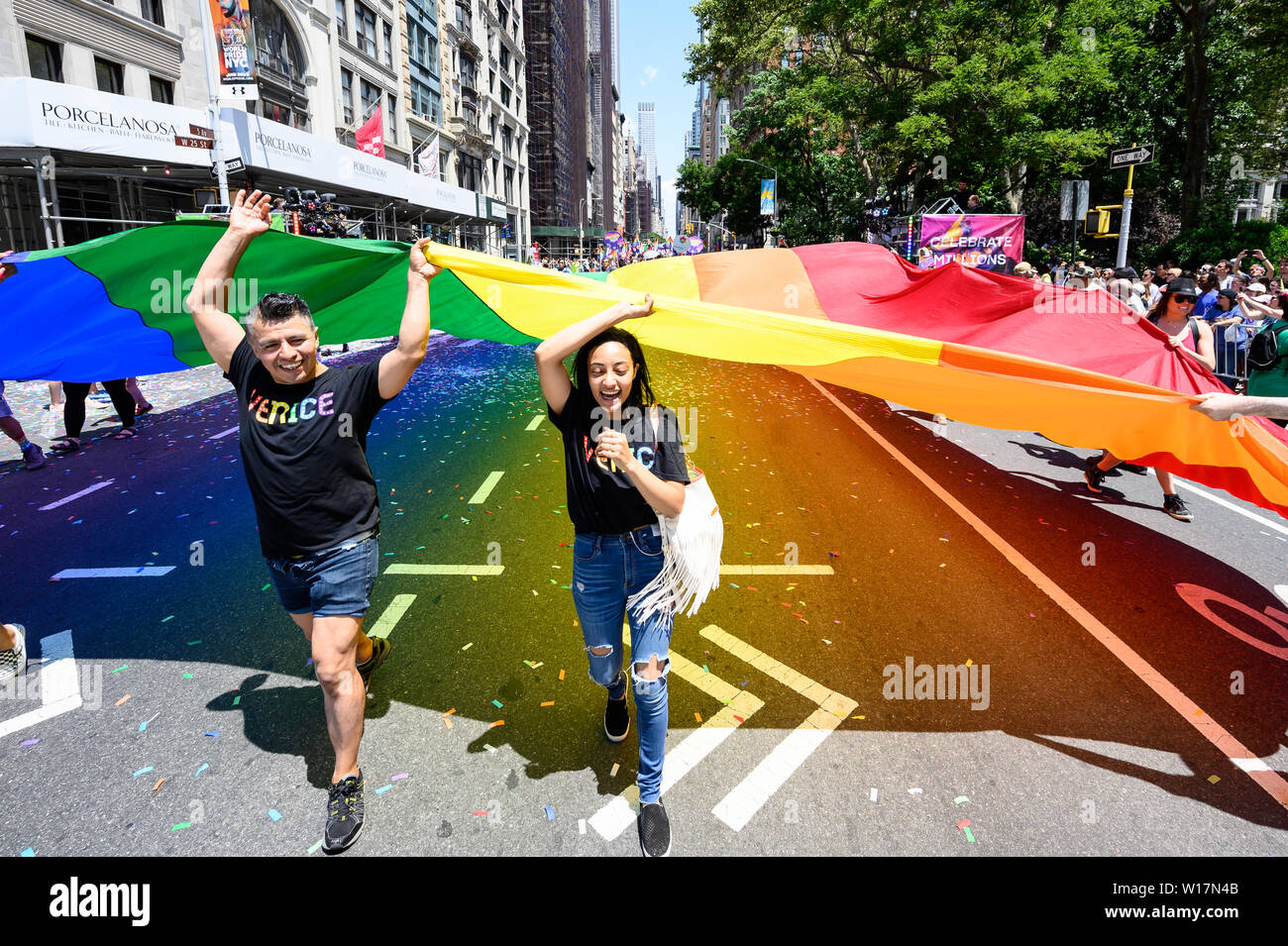 Participants carry a huge flag during the New York City Pride March on ...