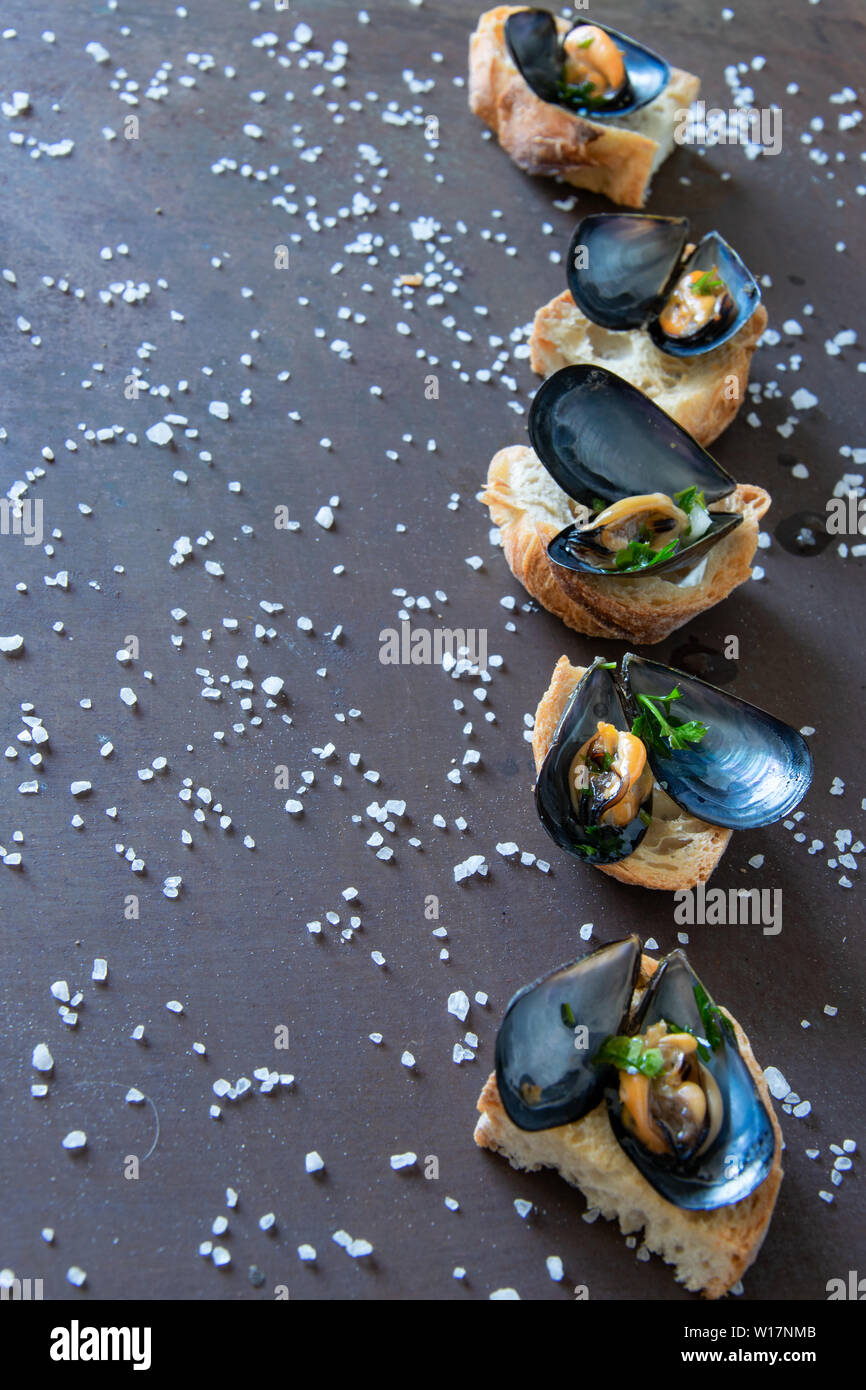 Cooked delicious black mussel with toasted bread. Healthy eating ...